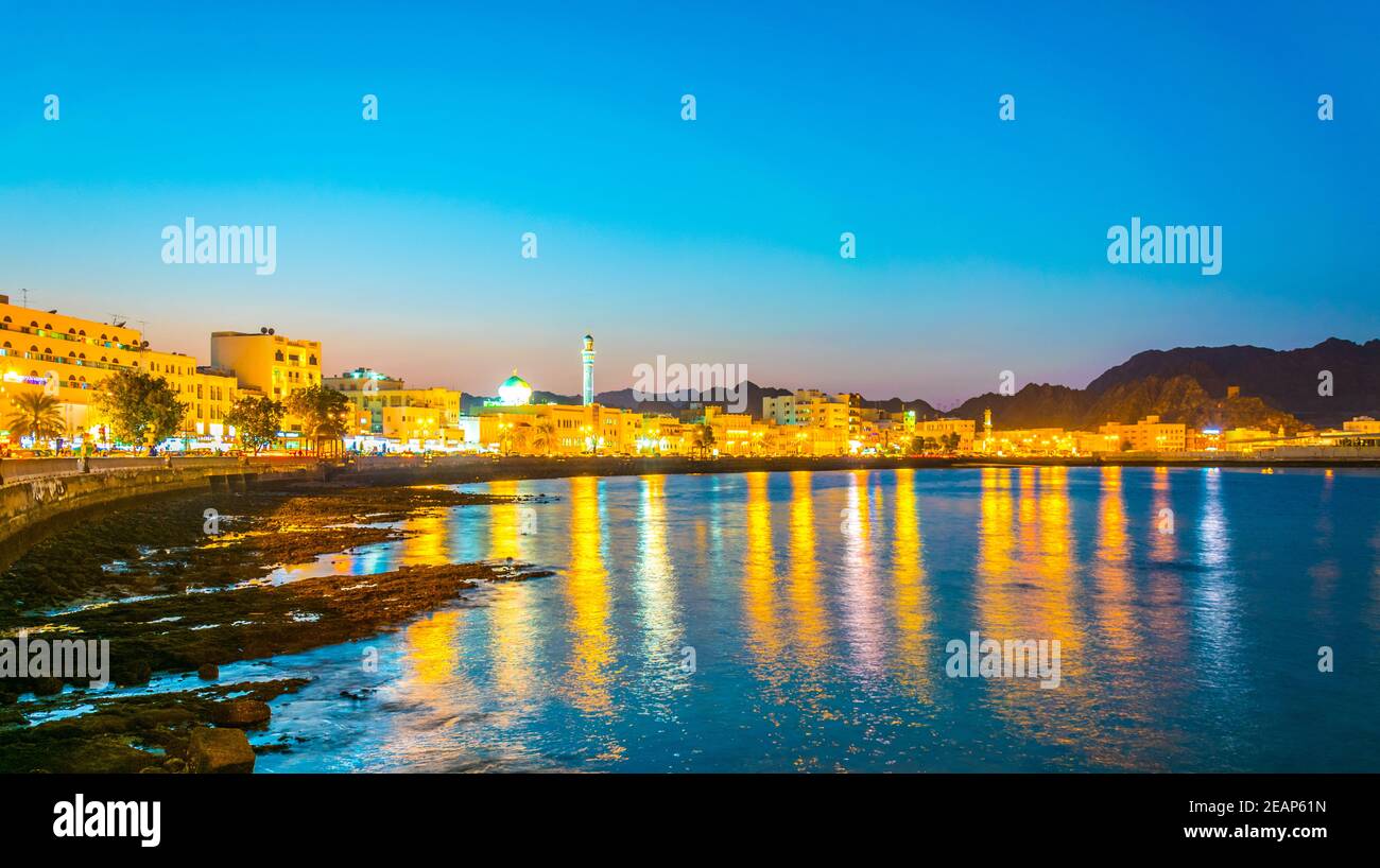 View of coastline of Muttrah district of Muscat during sunset, Oman ...
