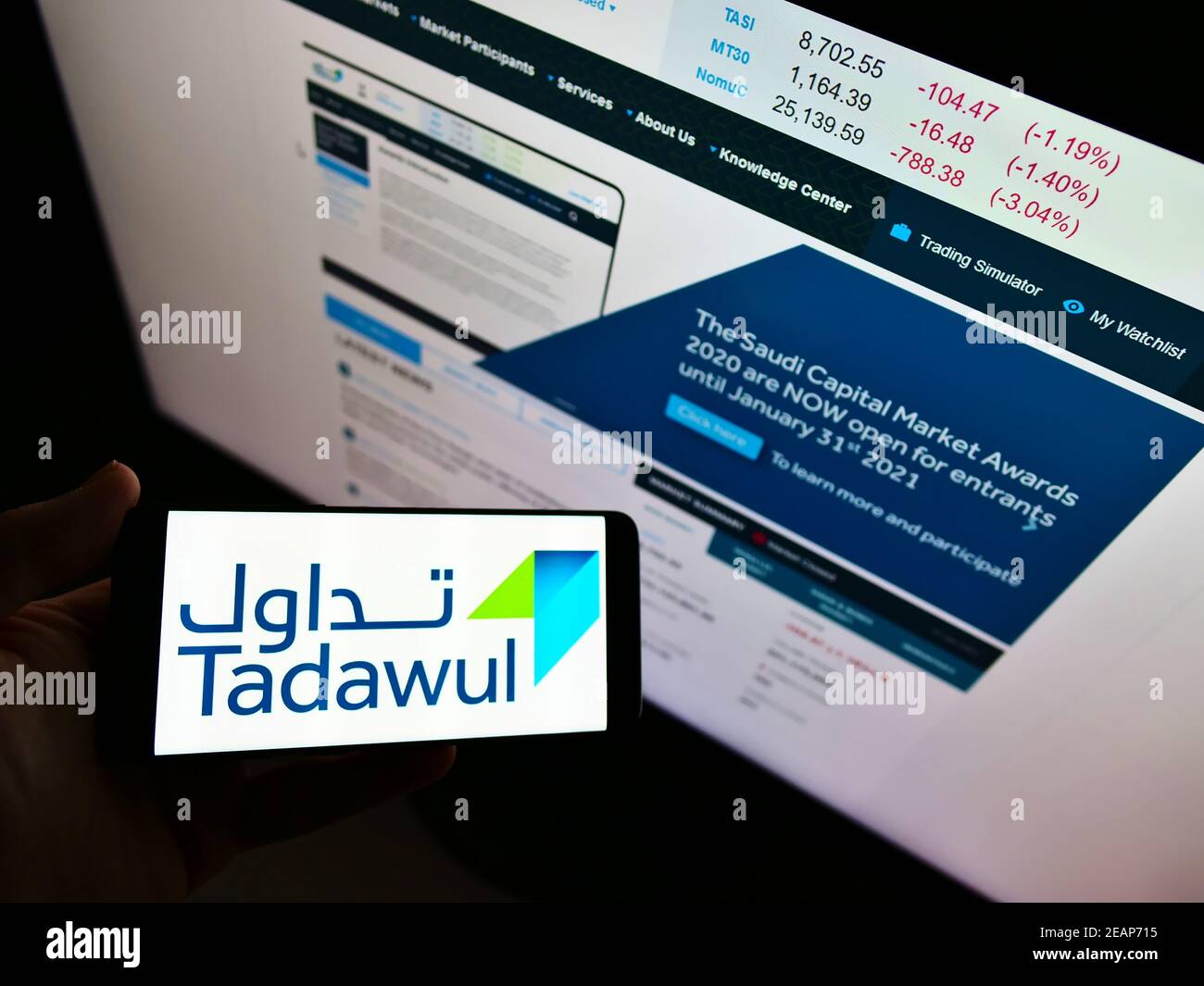 Person holding smartphone with business logo of Saudi Arabian stock ...