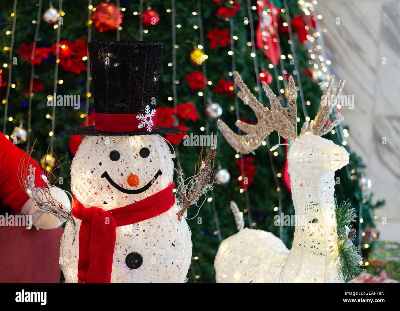 Smiling face snowman decoration and deer Stock Photo - Alamy