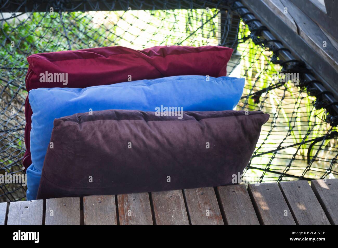 Colorful pillows on net seat among nature Stock Photo - Alamy