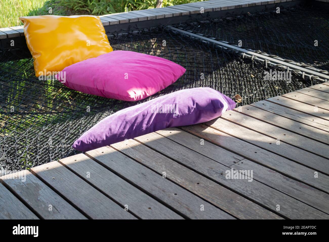 Colorful pillows on net seat among nature Stock Photo - Alamy