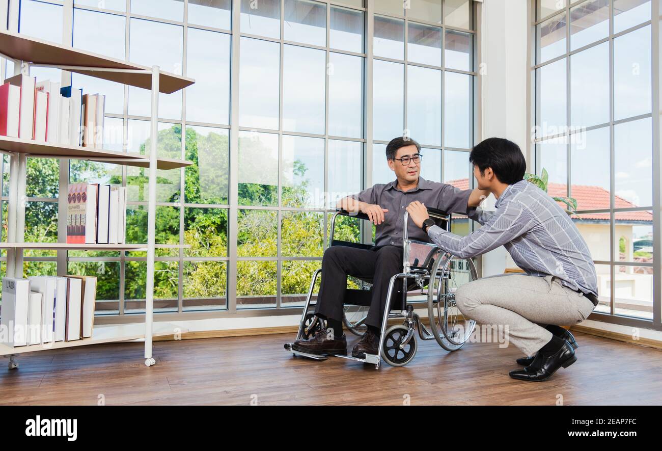 old man in a wheelchair and his young son Stock Photo - Alamy