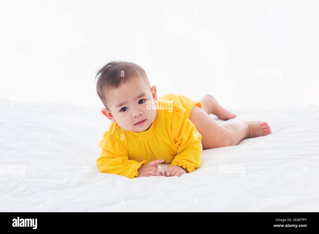 newborn little baby prone on the bed at home Stock Photo - Alamy