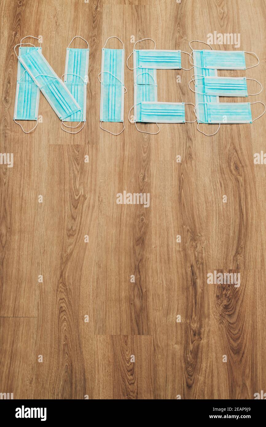Word Nice Composed of Medical Masks on a Brown Background with Copy ...