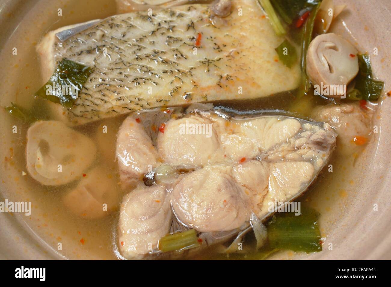 spicy slice pomfret or butter fish and straw mushroom in Tom Yum soup ...