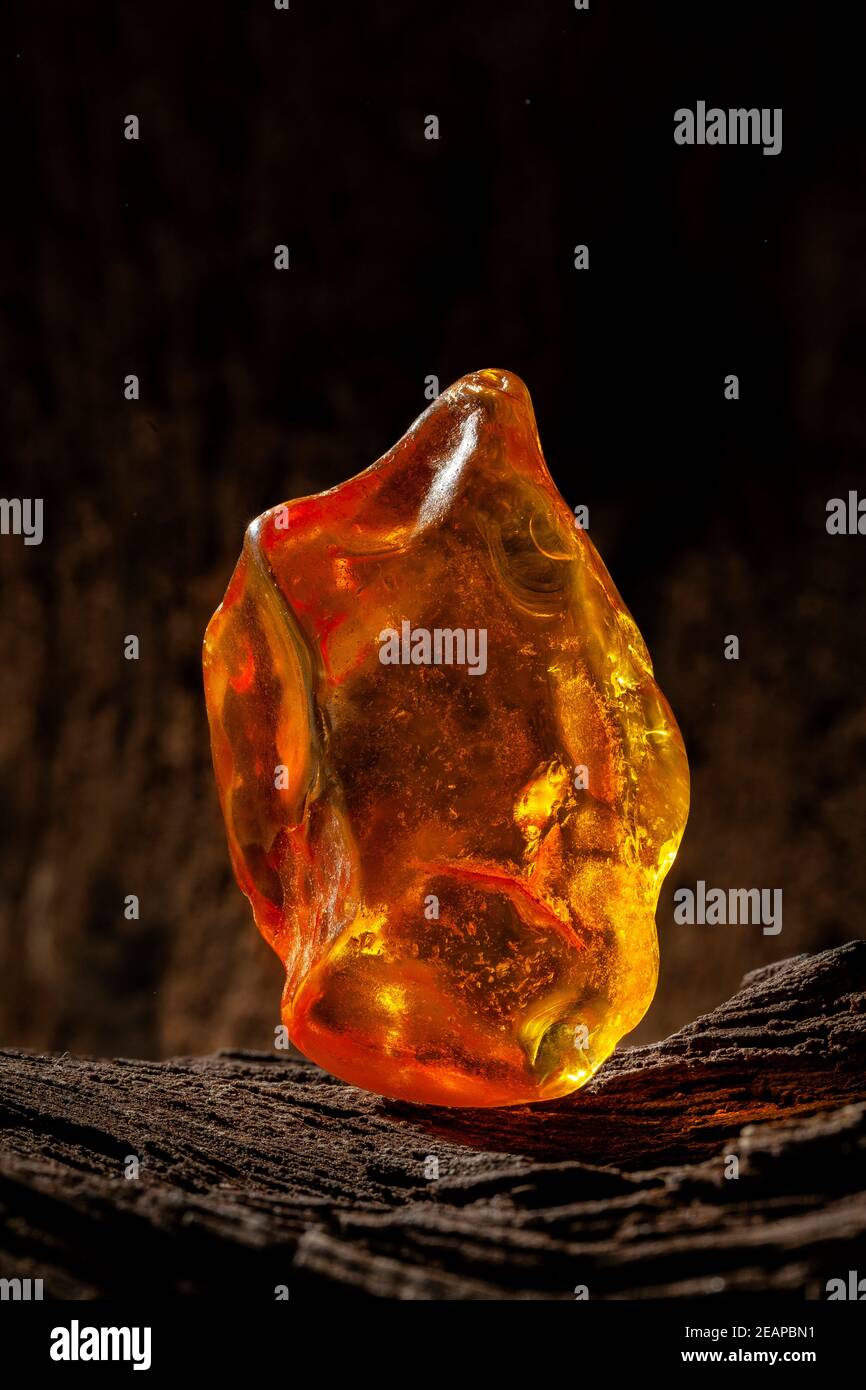 Beauty of natural raw amber. A piece of yellow opaque natural amber on ...