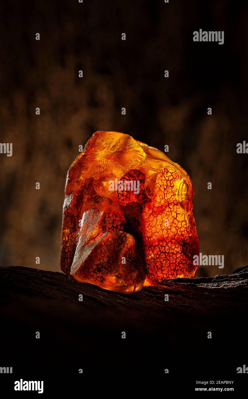 Beauty of natural raw amber. A piece of yellow and red semi transparent ...