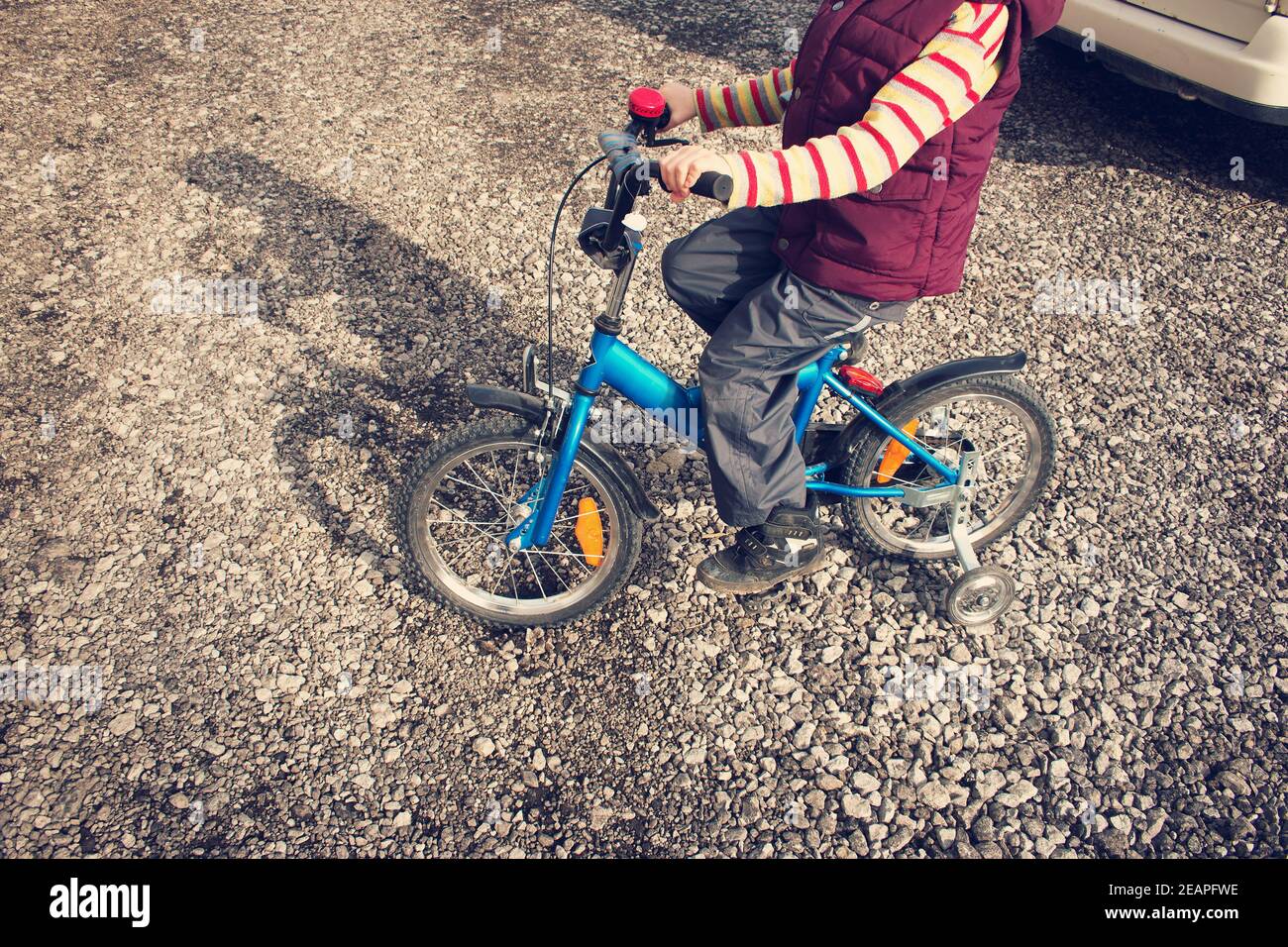 Boy on bike at gravel road Stock Photo - Alamy