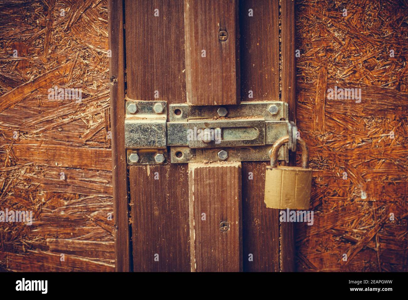 Latch and a padlock on a door Stock Photo - Alamy