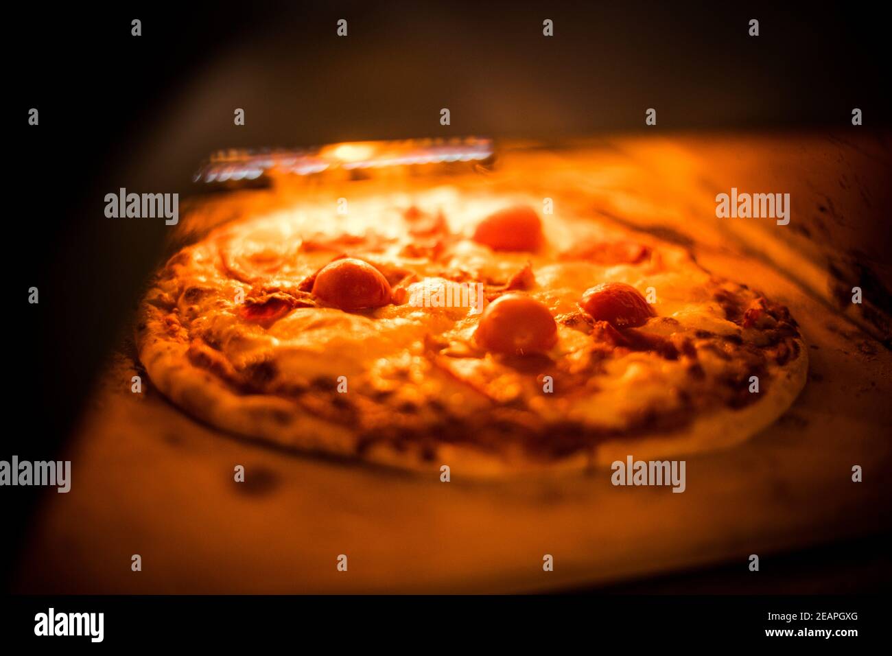 Pizza baking in an oven Stock Photo - Alamy