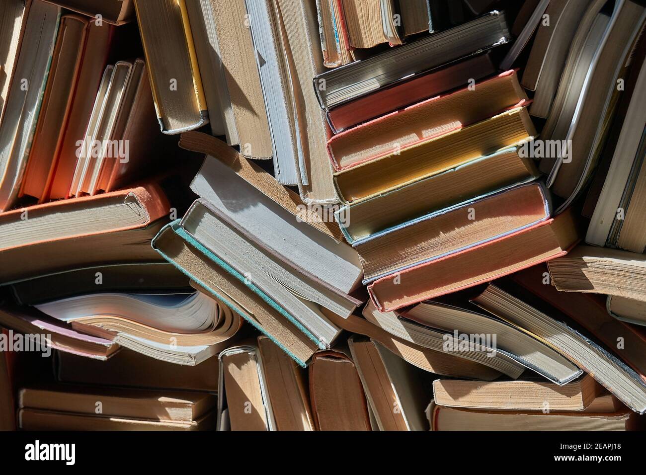 Wall of books piled up Stock Photo - Alamy