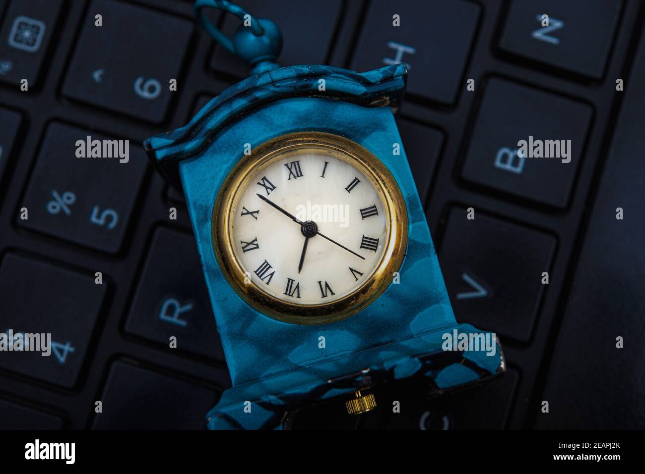 Vintage clock miniature on keyboard closeup view Stock Photo - Alamy