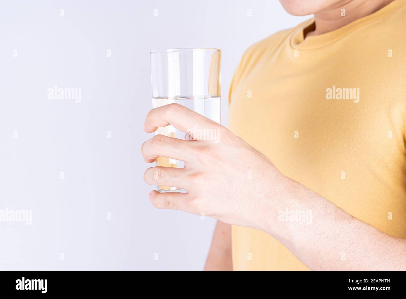 Man holding glass of water isolated grey background. Clean drinking water in clear glass Stock ...