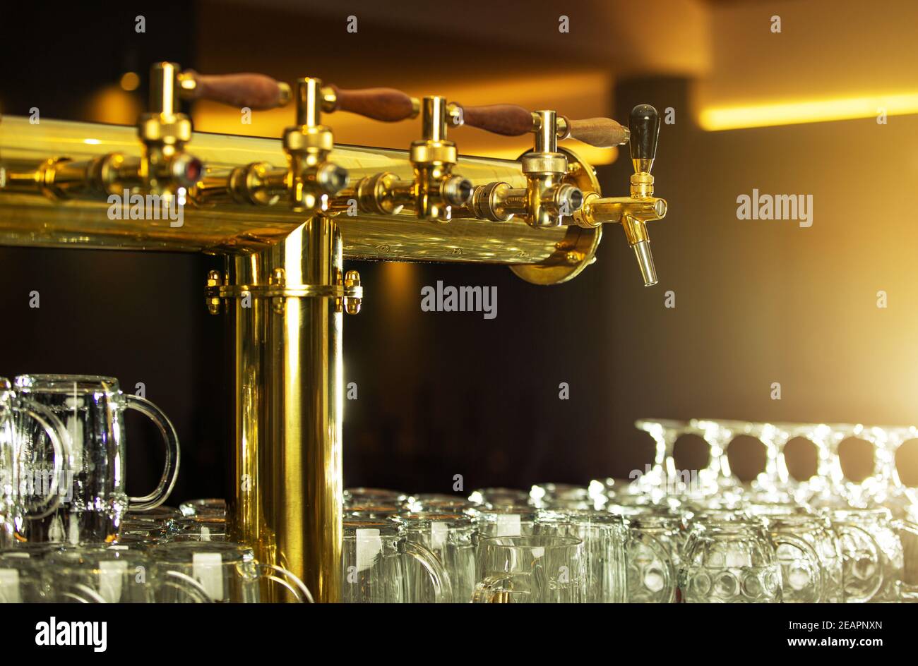 Close up of a beer faucet or tap with huge arrenge of an empty glasses ...