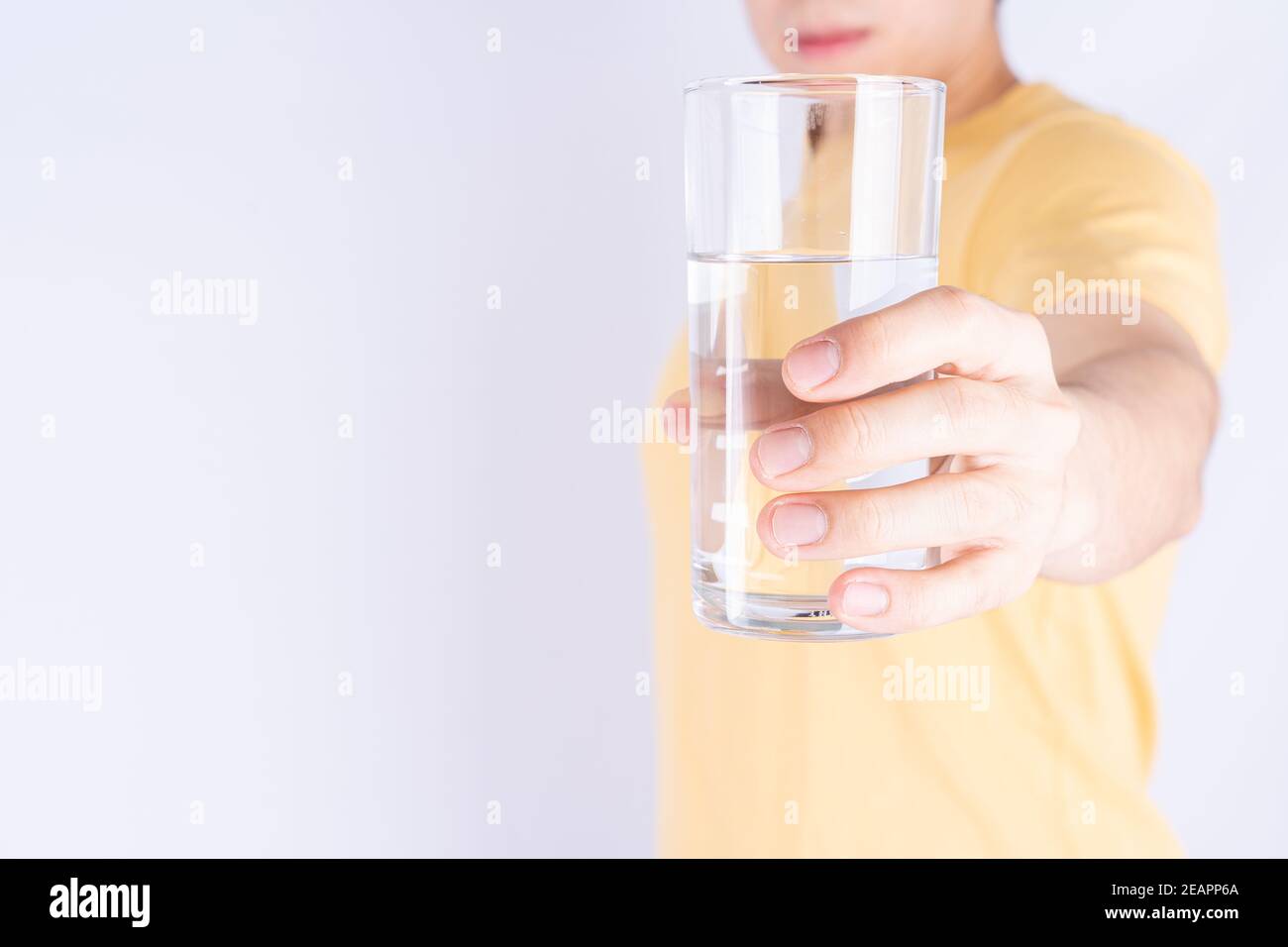 Man holding glass of water isolated grey background. Clean drinking water in clear glass Stock ...