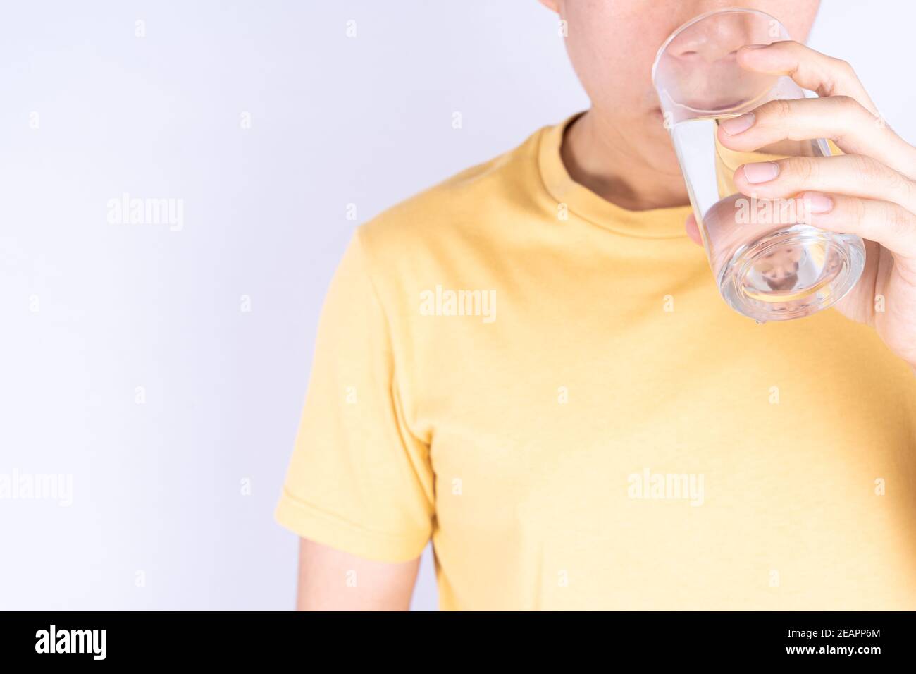 Man drinking water isolated grey background. Clean drinking water in ...