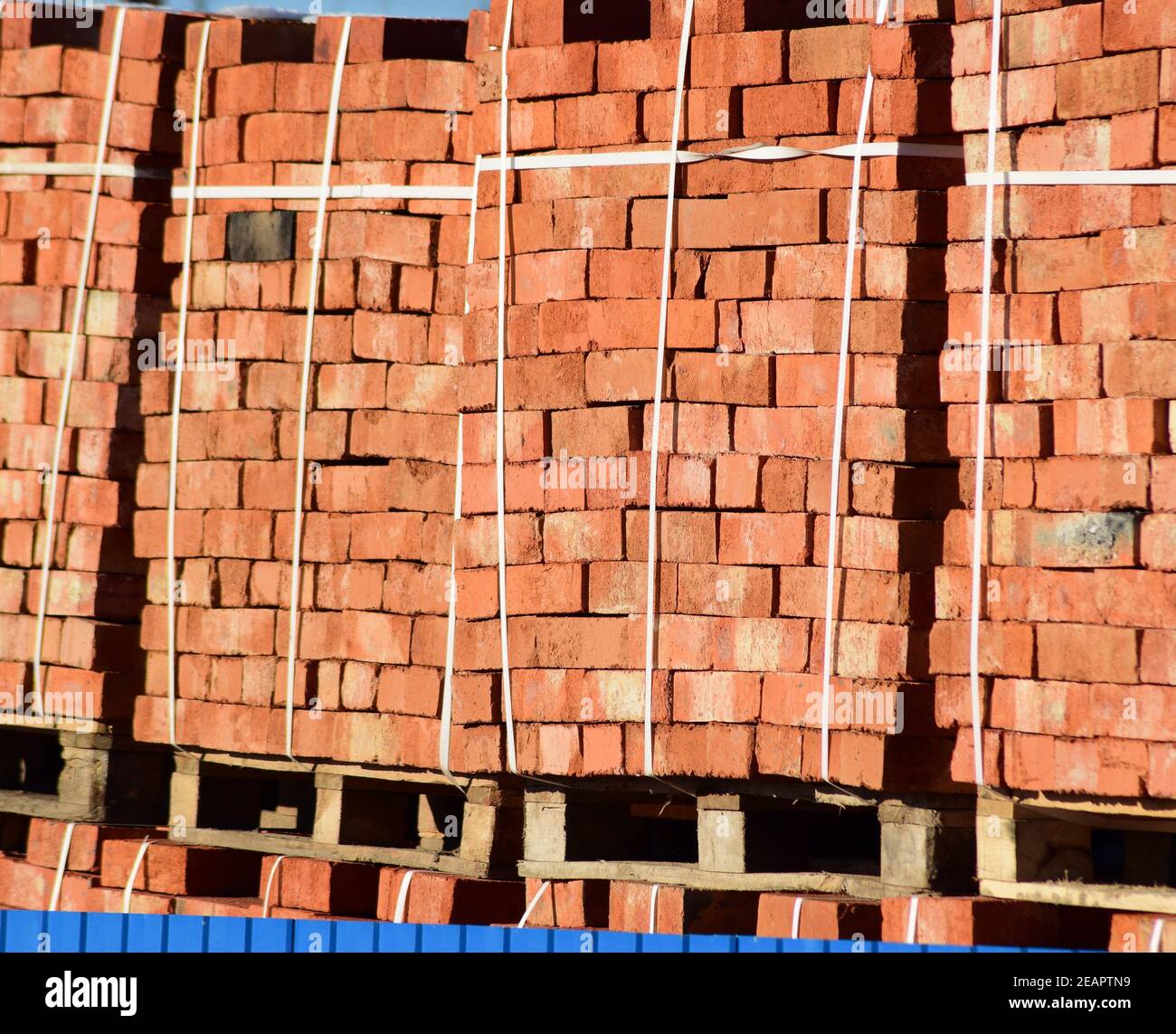 Red bricks stacked into cubes. Warehouse bricks. Storage brickworks ...