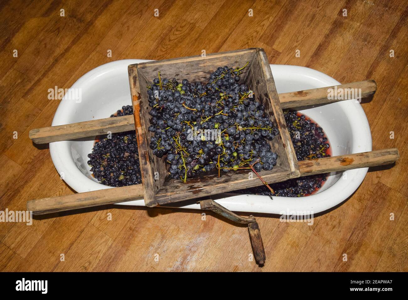 Manual mechanism for crushing grapes. Crush the grapes into juice and ...