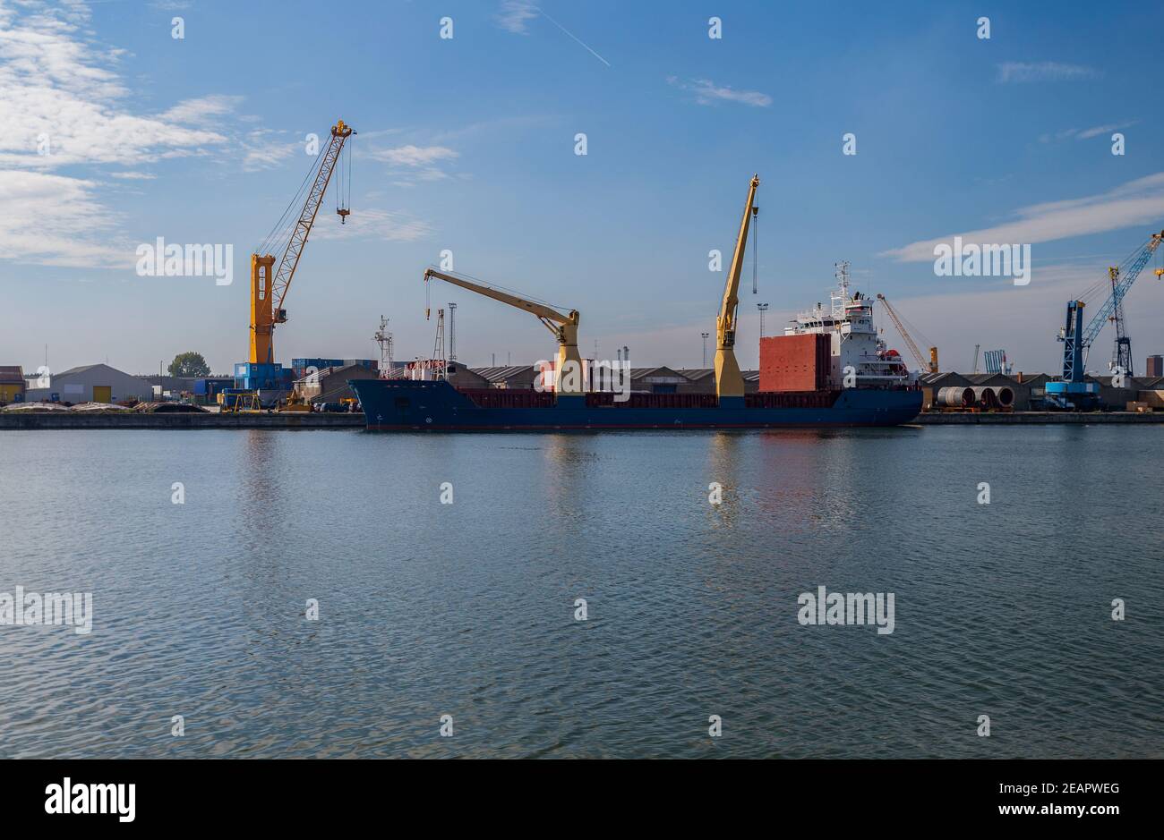 The photo shows a freighter unloading at a mooring quay Stock Photo - Alamy
