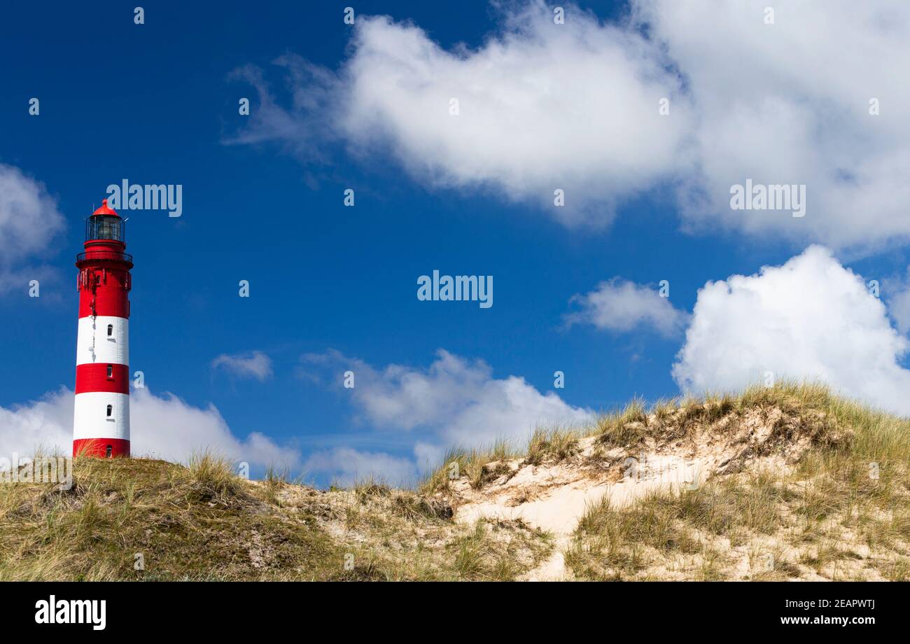 The photo shows the Amrum lighthouse in the dunes with beautiful sky ...