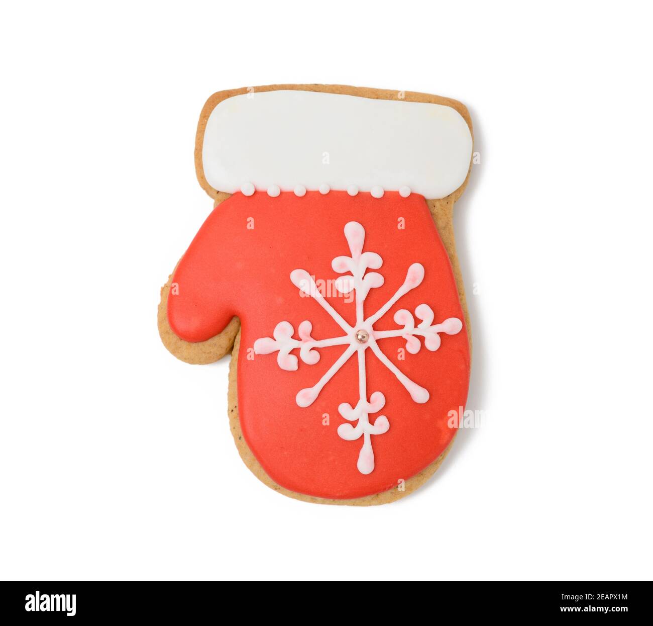 mitten shaped baked christmas cookies with red sugar icing isolated on ...