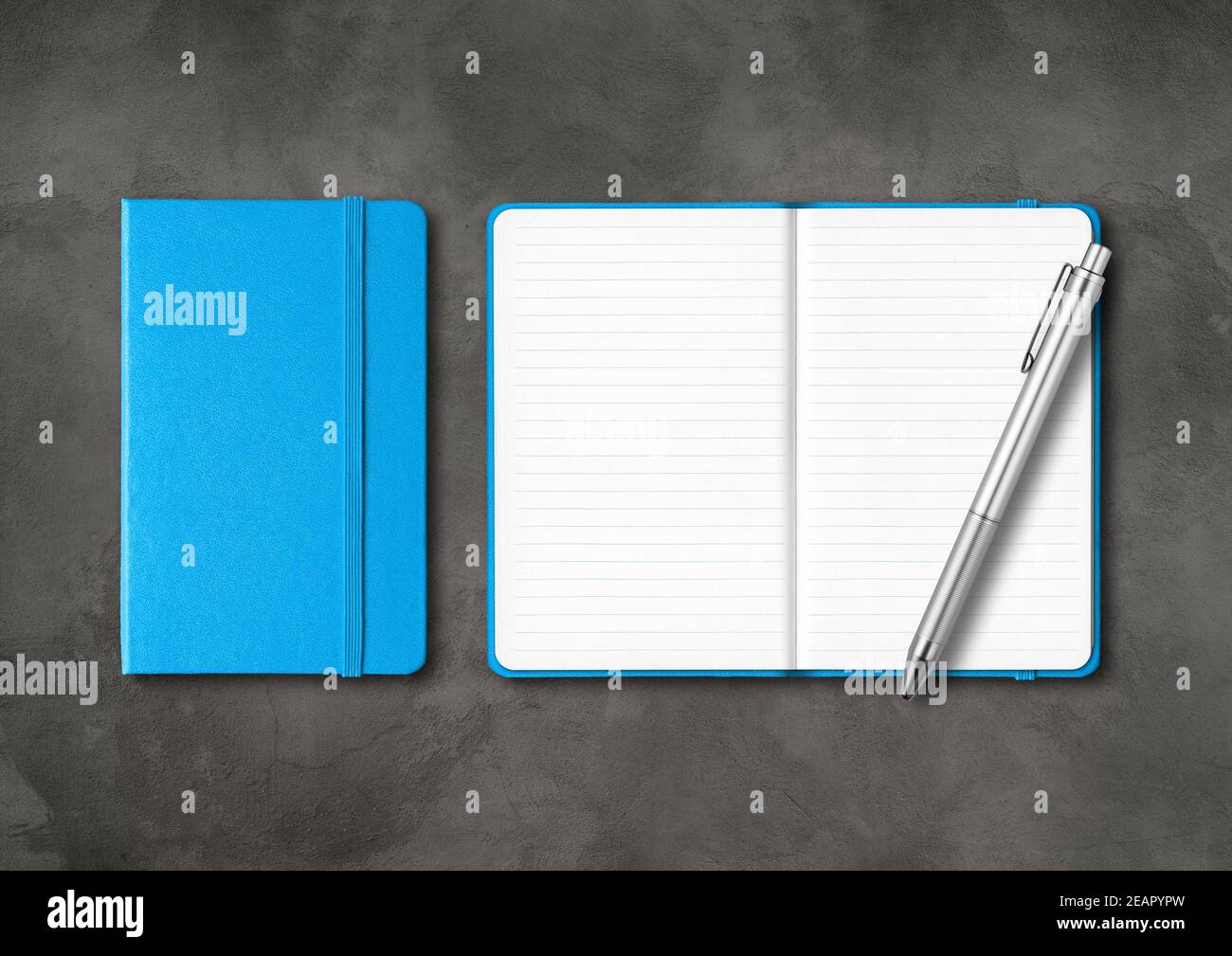 Blue closed and open lined notebooks with a pen on dark concrete ...