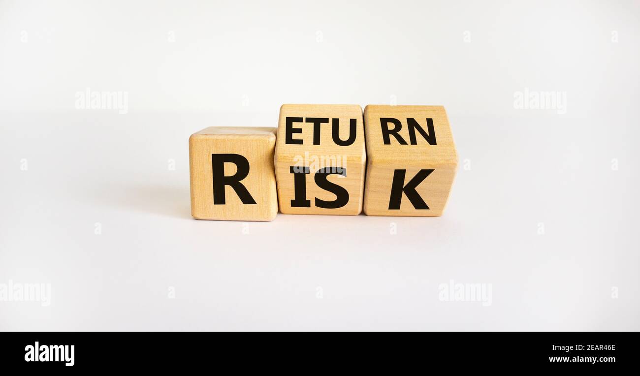 Risk or return symbol. Turned wooden cubes and changed the word 'risk ...