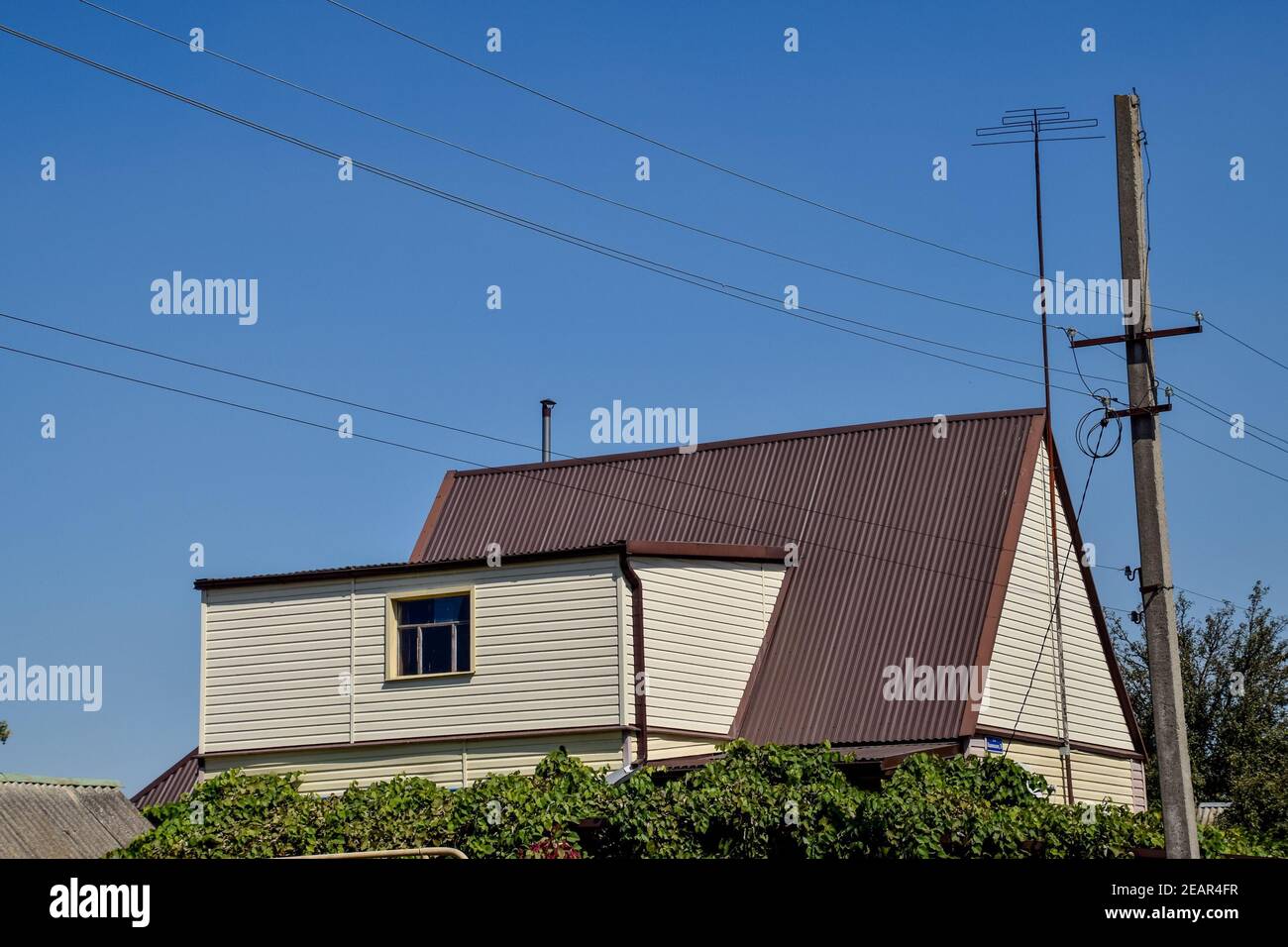 Detached house with a roof made of steel sheets Stock Photo - Alamy
