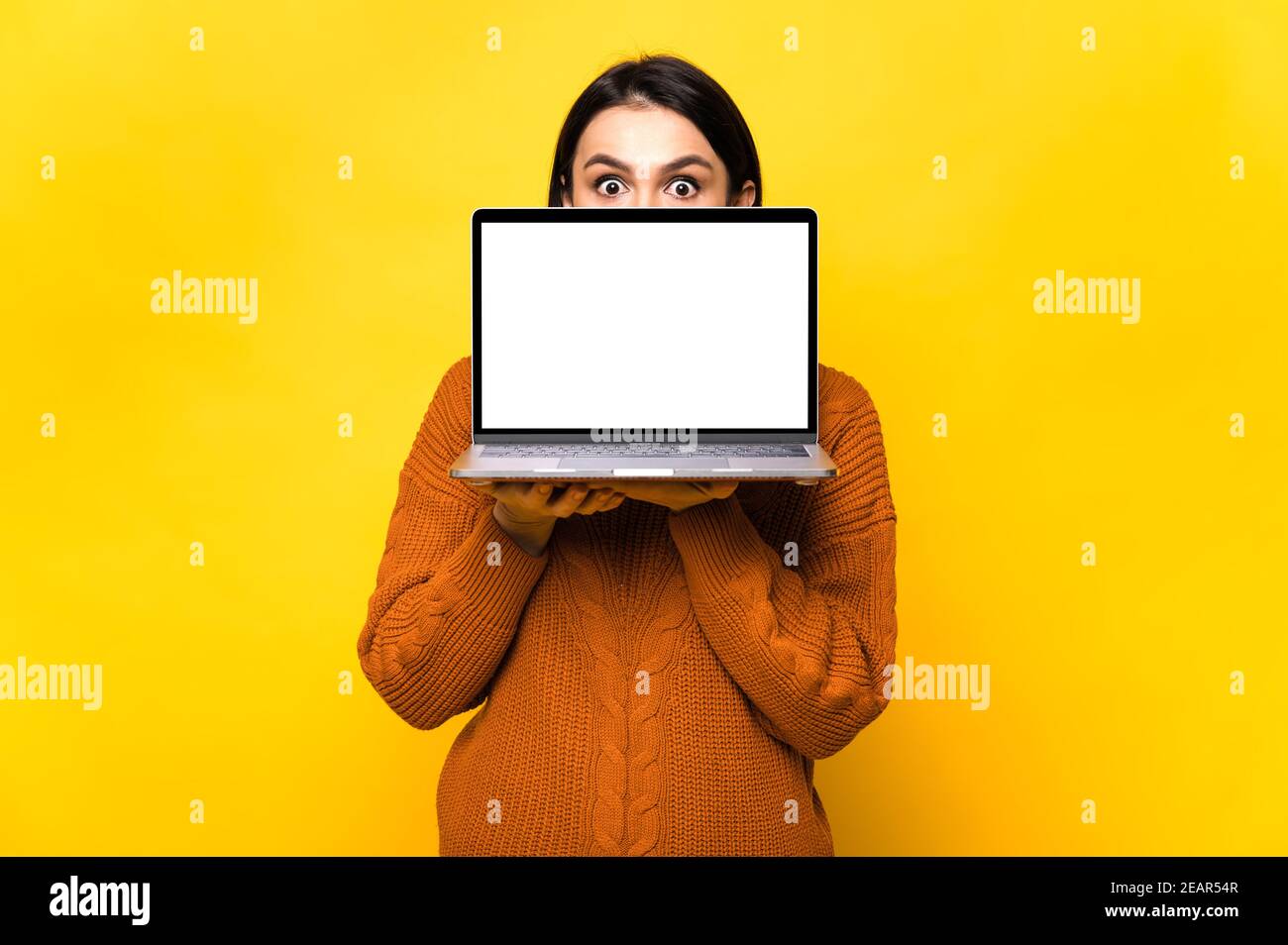 Surprised shocked caucasian young woman, hiding behind blank white ...