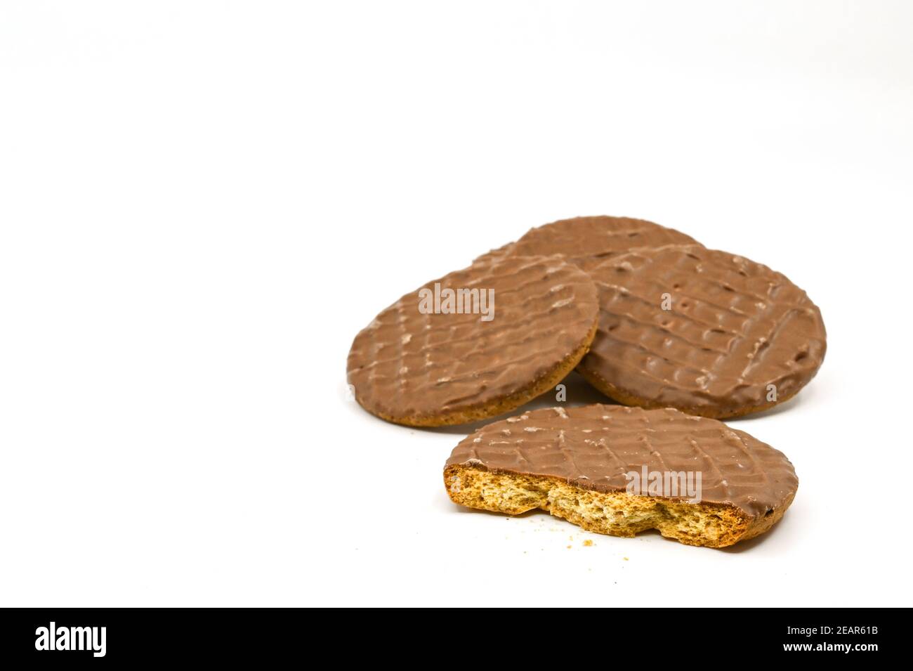 Broken chocolate covered biscuit against a plain white background, with ...