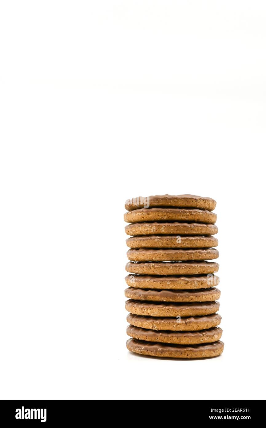 Stack of chocolate covered biscuits against a plain white background ...