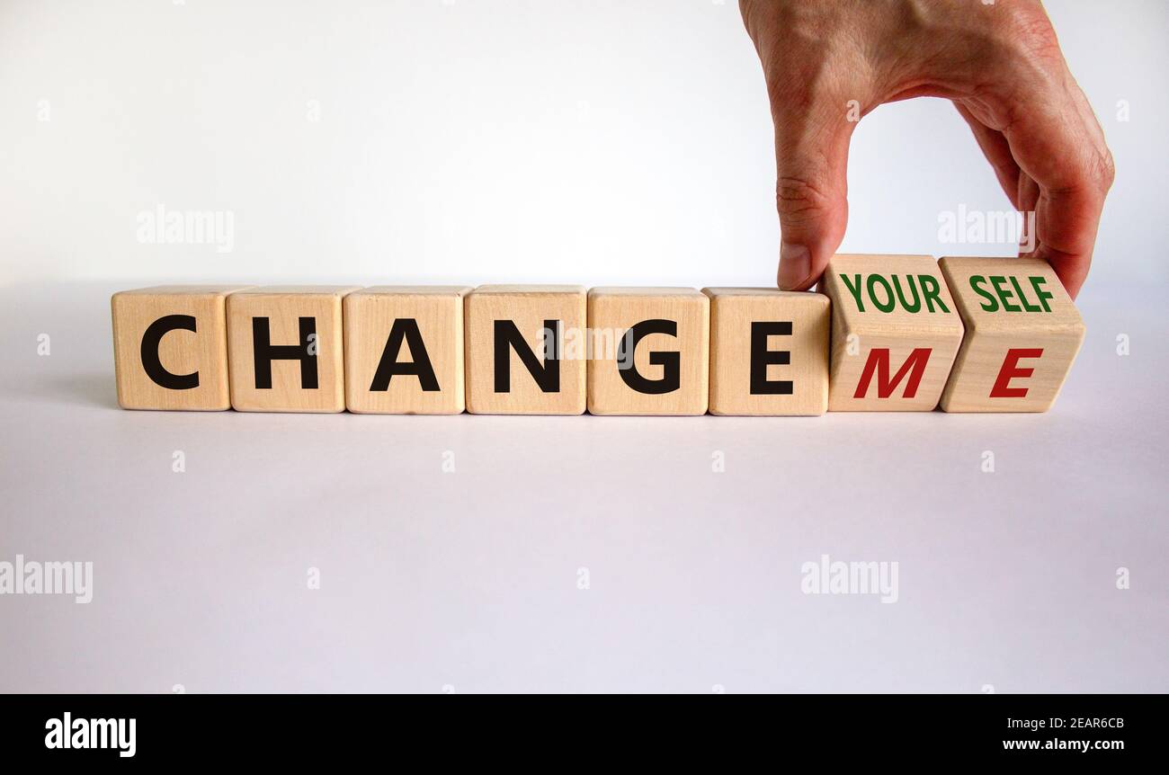 Change yourself or me symbol. Businessman turns wooden cubes and ...