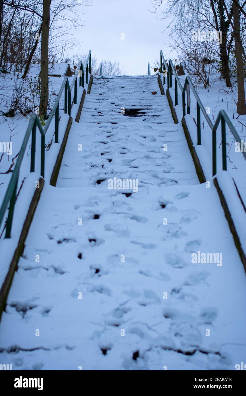 A Snow Covered Stairway With Footsteps Stock Photo - Alamy