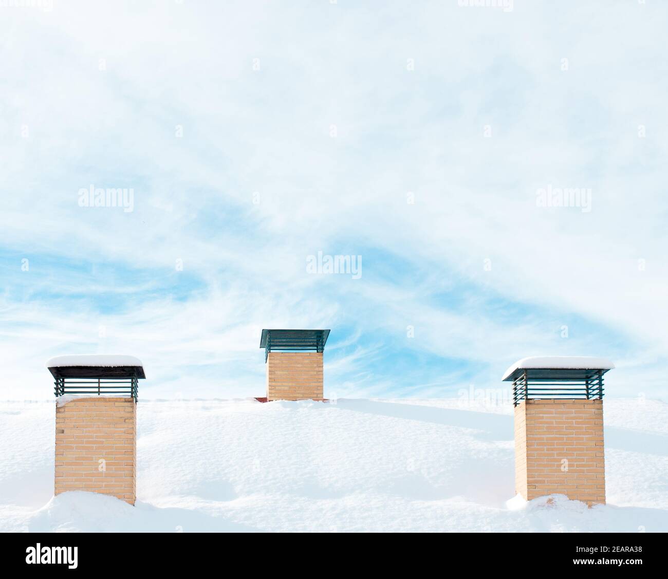 Three chimneys between snow and sky Stock Photo - Alamy