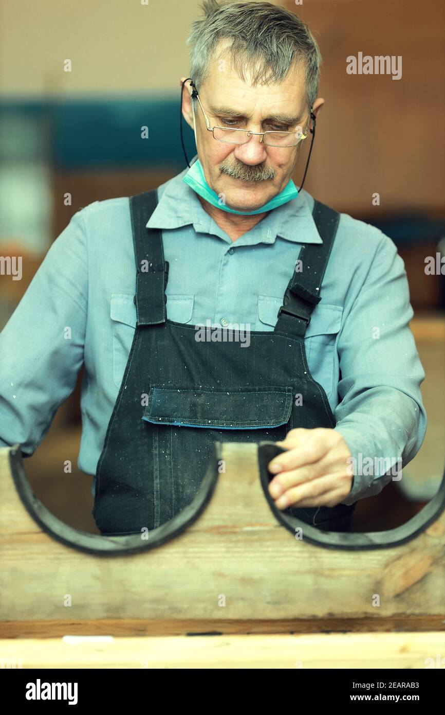 Portrait of an elderly carpenter in the workshop at work Stock Photo ...