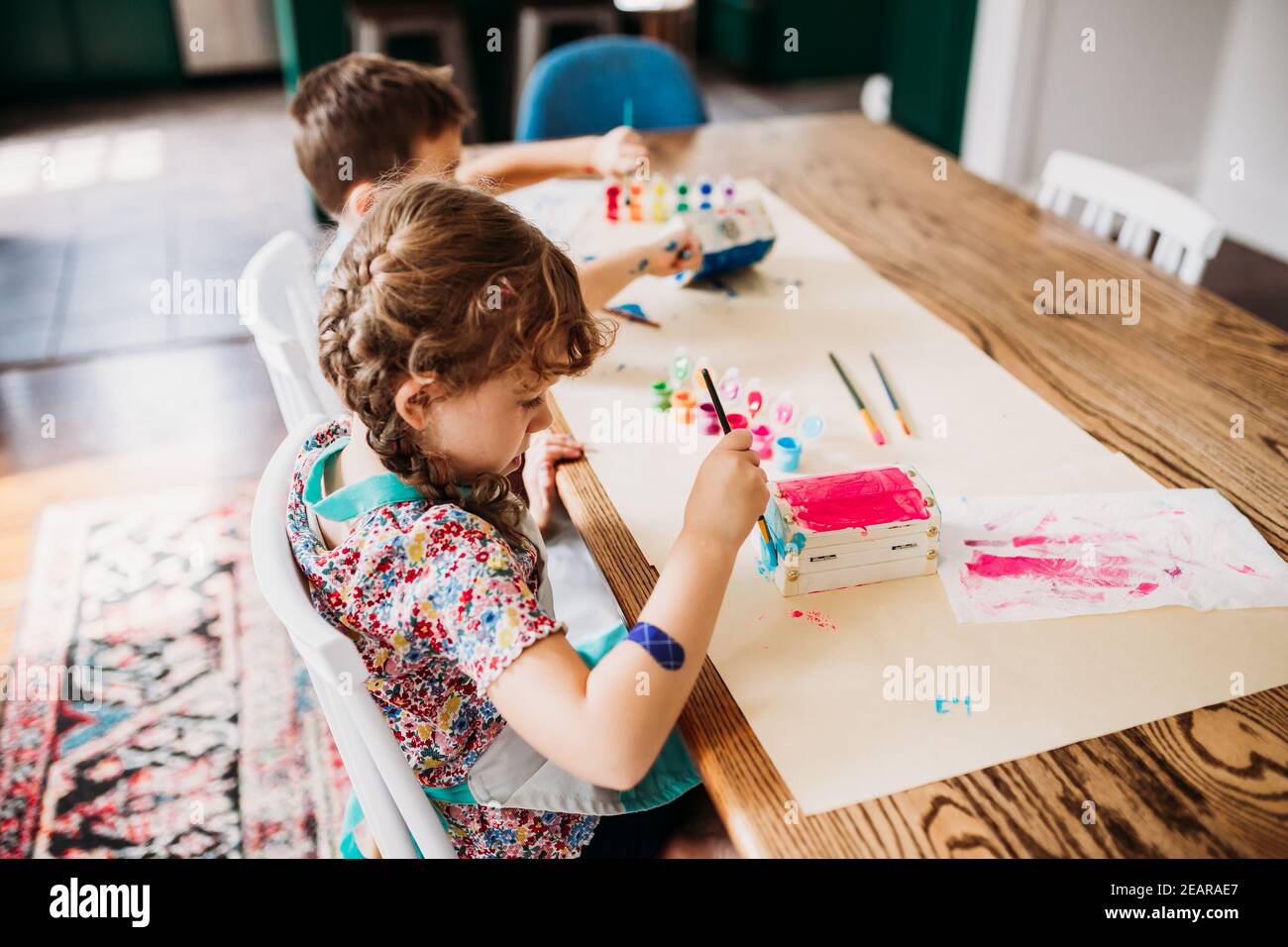Young kids doing arts and crafts with rainbow colored paint Stock Photo ...
