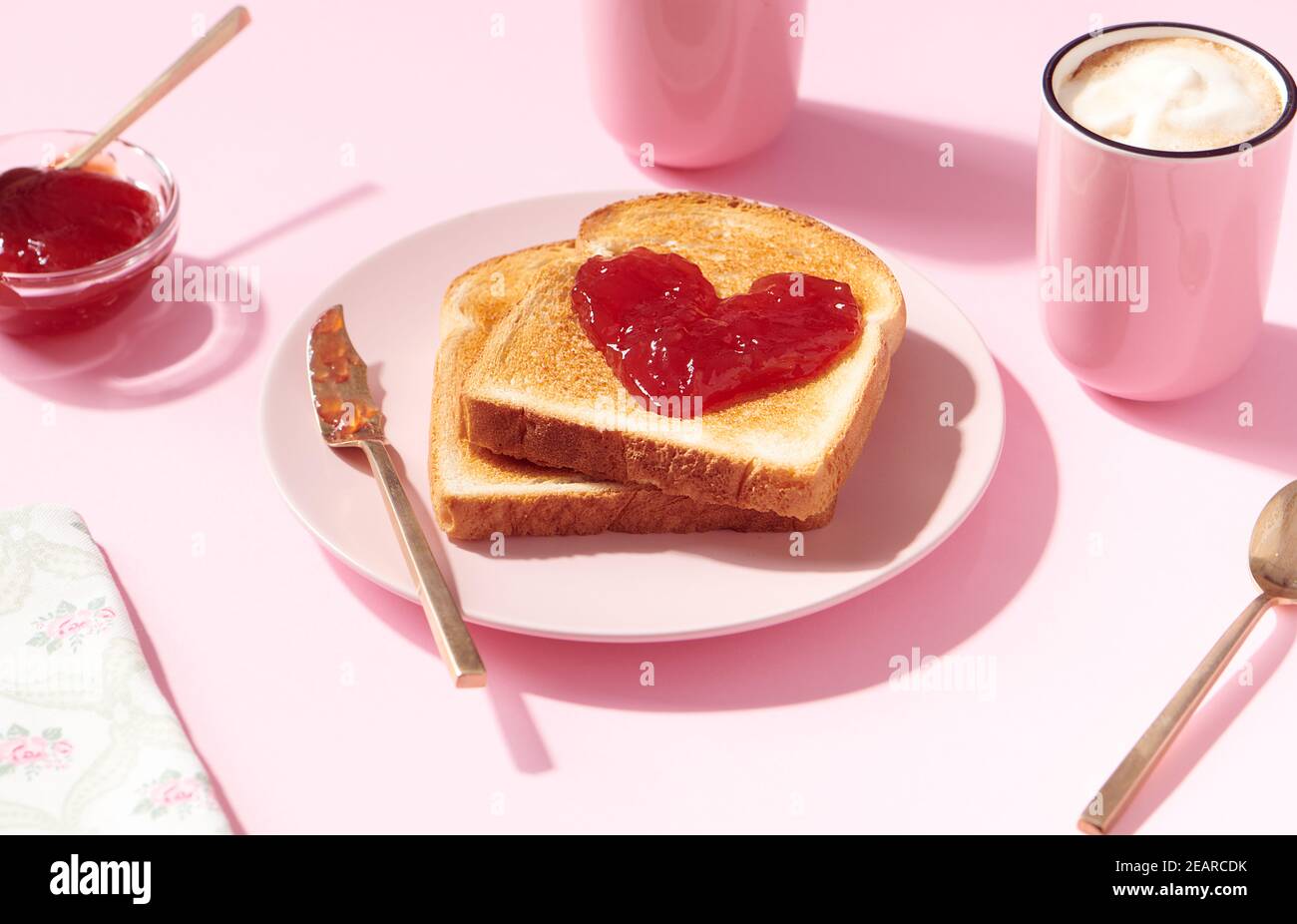 Toast with heart shaped strawberry jam on it as a concept for love and ...