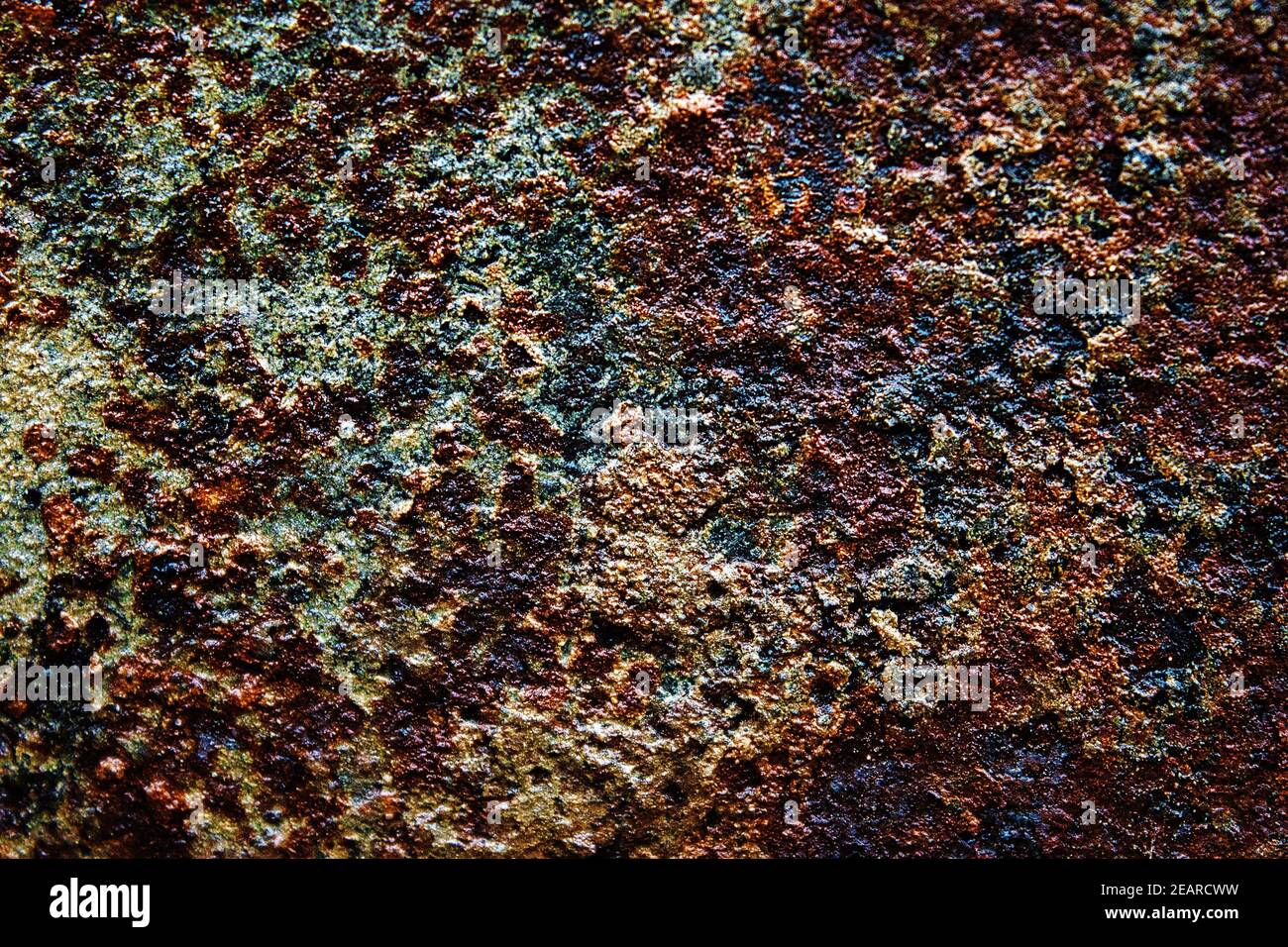 It's an old, rusty, dark-colored metal surface. Abstract background ...