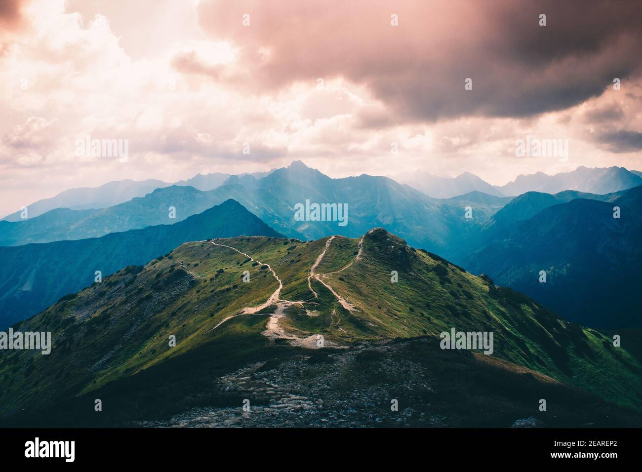 Mountain path with sun and clouds Stock Photo - Alamy