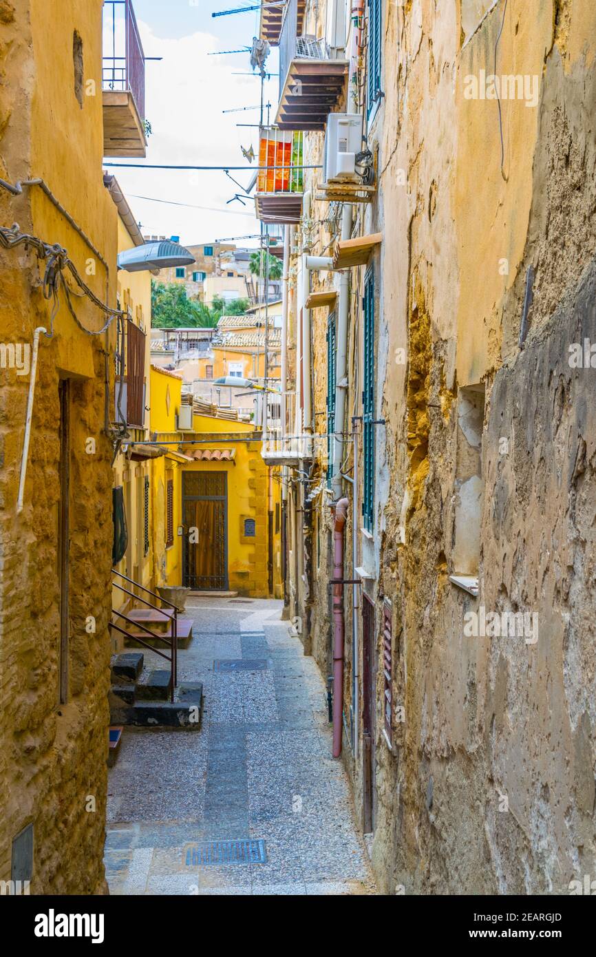 View of a narrow street in the historical city of Agrigento in Sicily ...