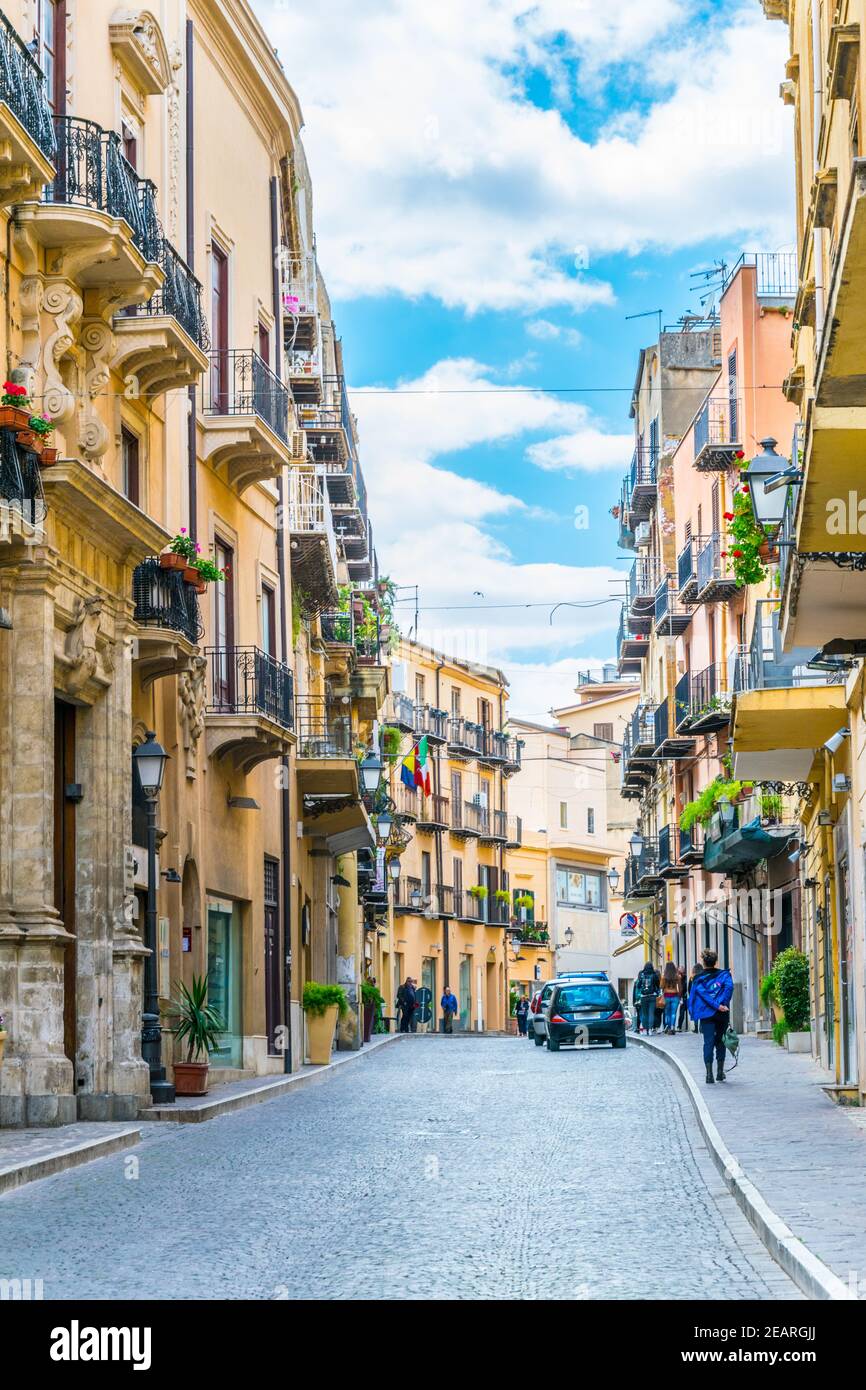View of a narrow street in the historical city of Agrigento in Sicily ...