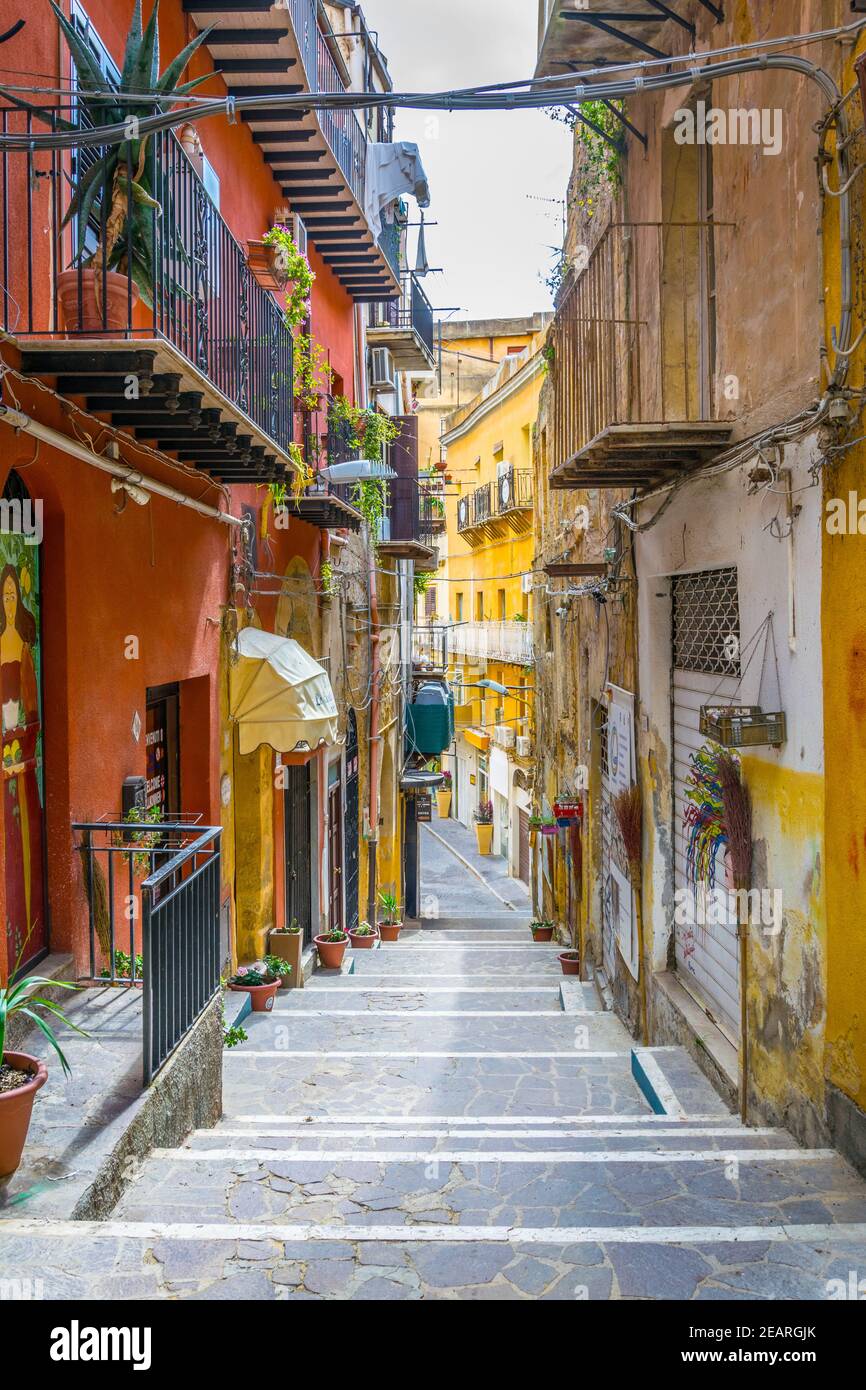 View of a narrow street in the historical city of Agrigento in Sicily ...