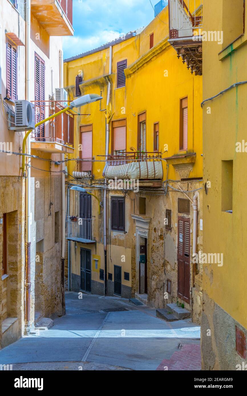 View of a narrow street in the historical city of Agrigento in Sicily ...