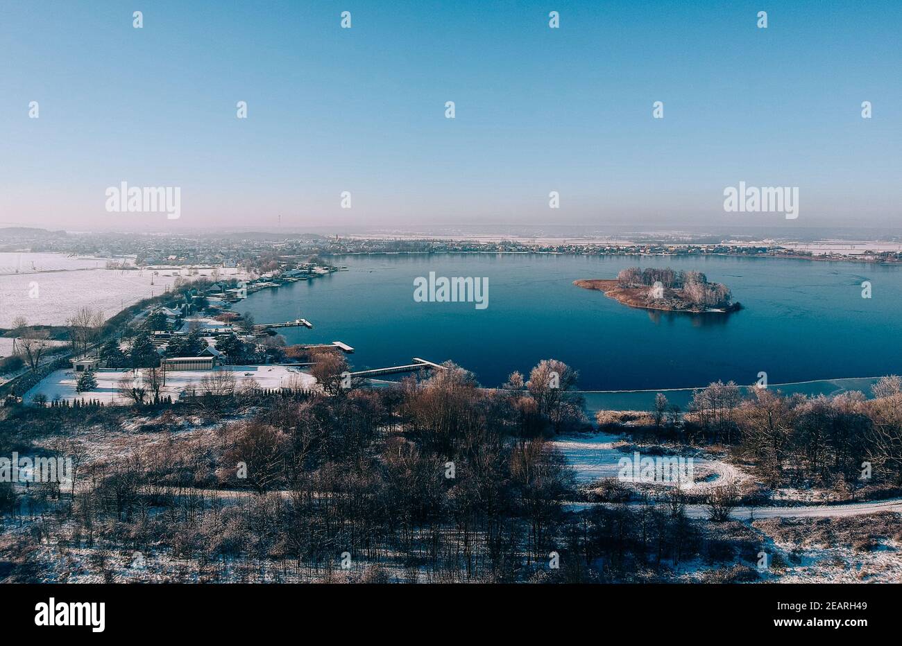 Aerial view of a lake near the land covered in deep snow Stock Photo ...