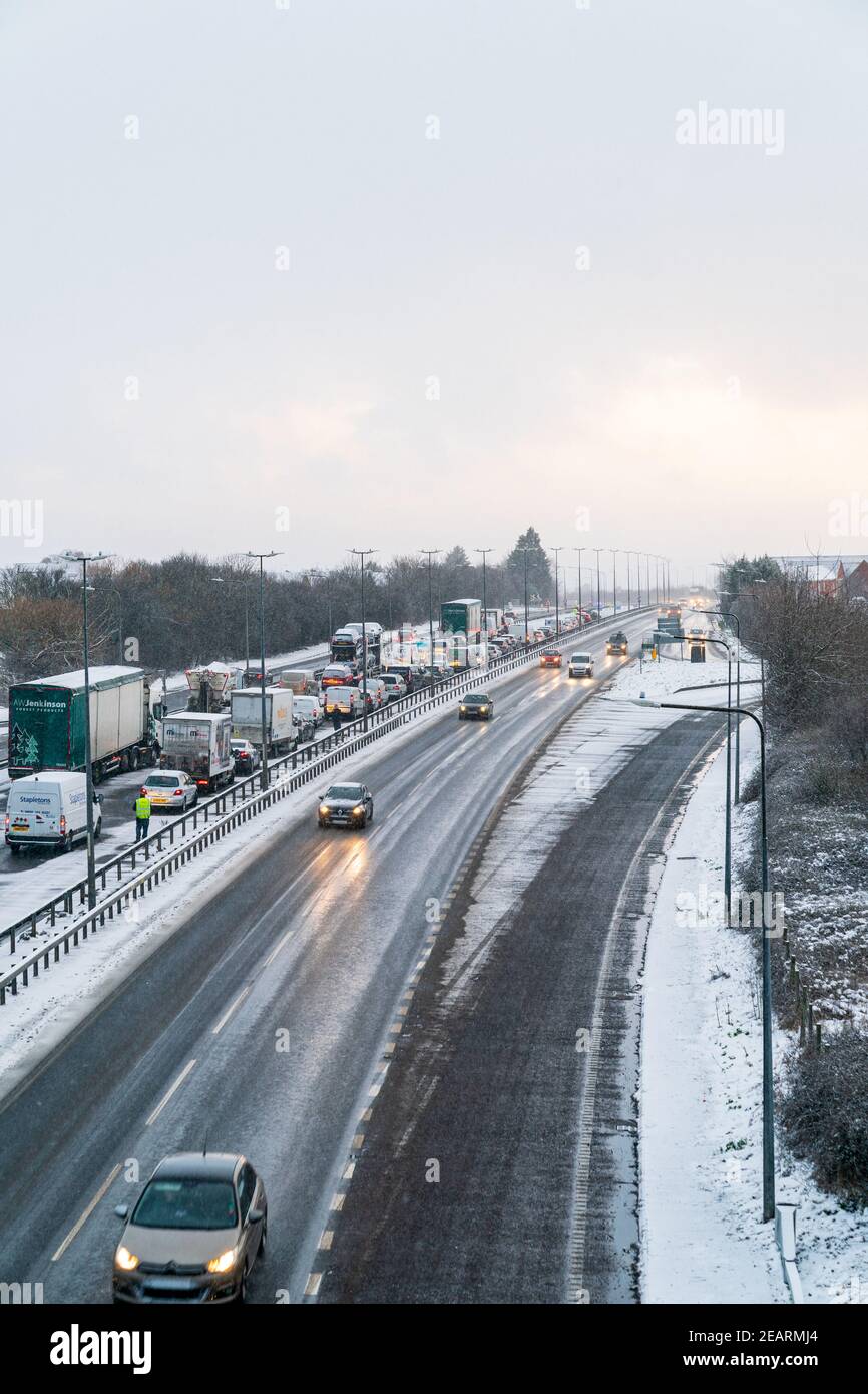 Traffic jam on two lanes during snow on a British dual carriageway, the ...