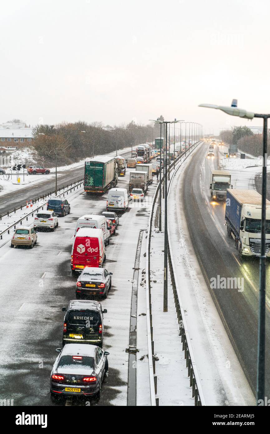 Traffic jam on two lanes during snow on a British dual carriageway, the ...