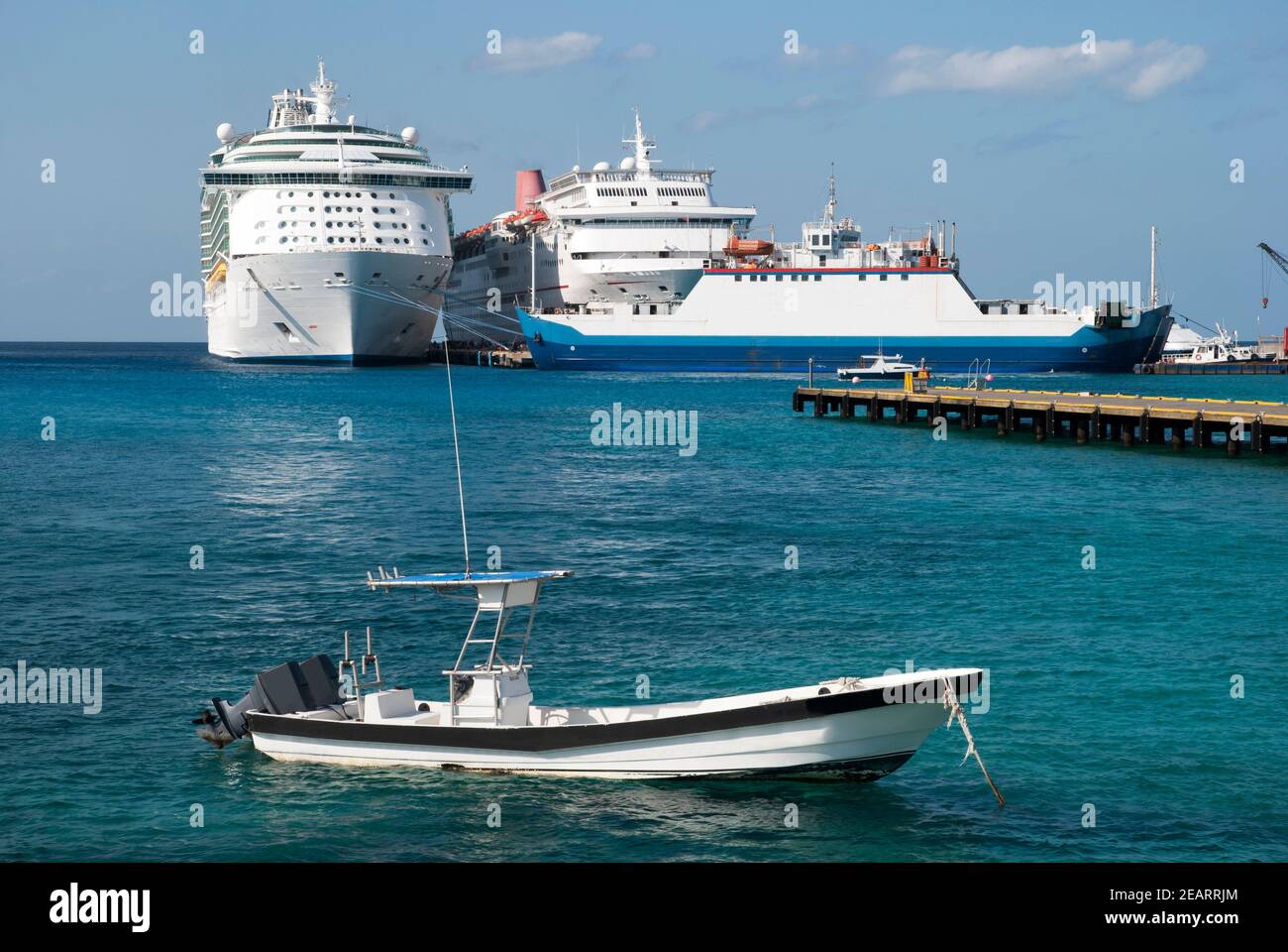 The view of a wooden motorboat with a ferry ship and cruise liners in a ...
