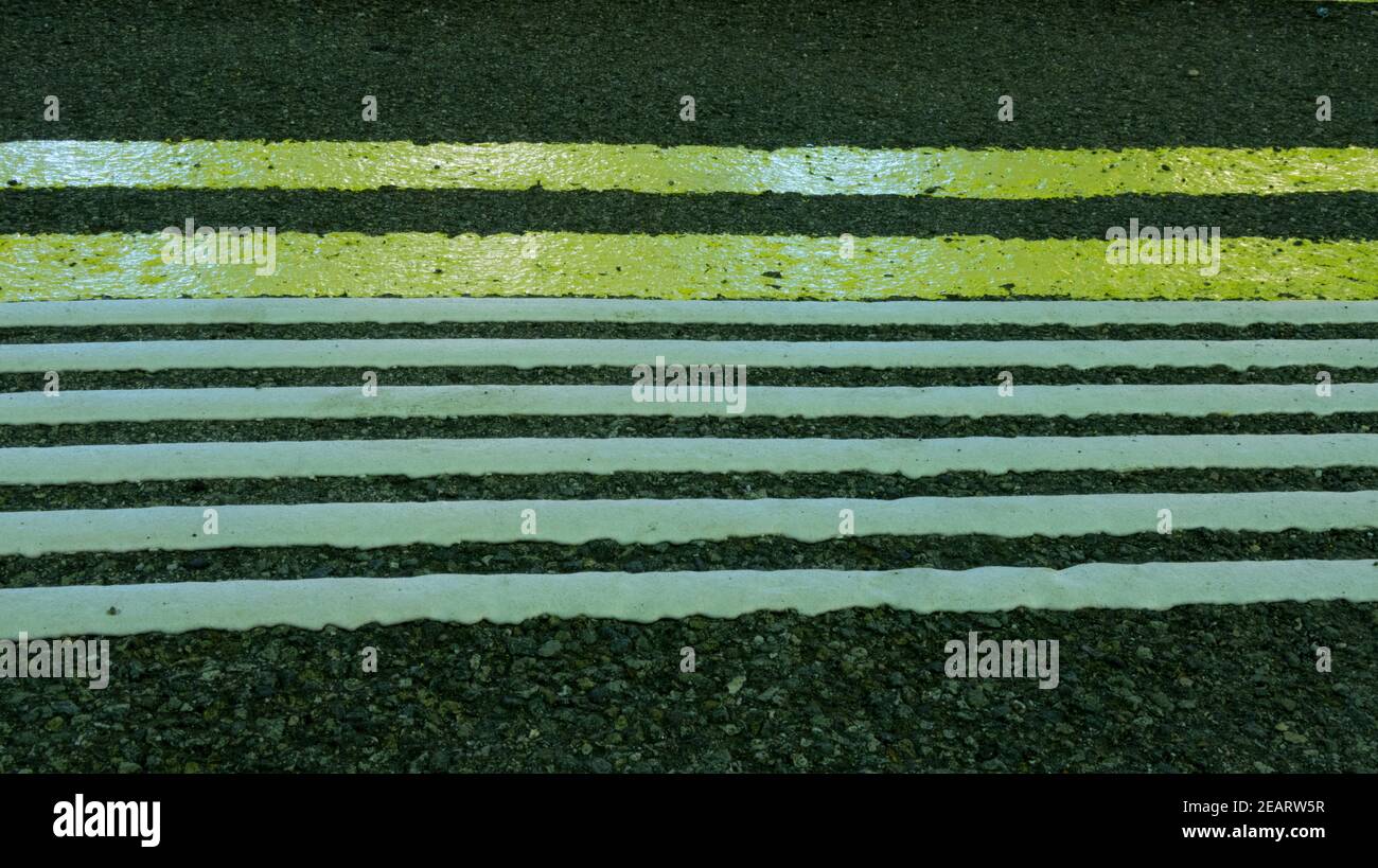 Line of hazard warning tactile paving along the edge of platform at the ...