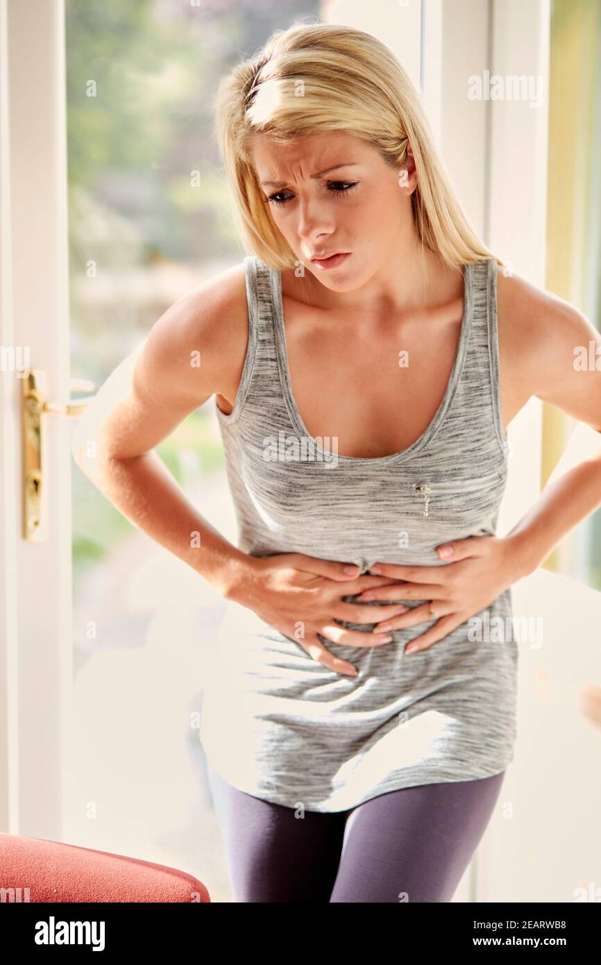 Woman with stomach ache Stock Photo - Alamy