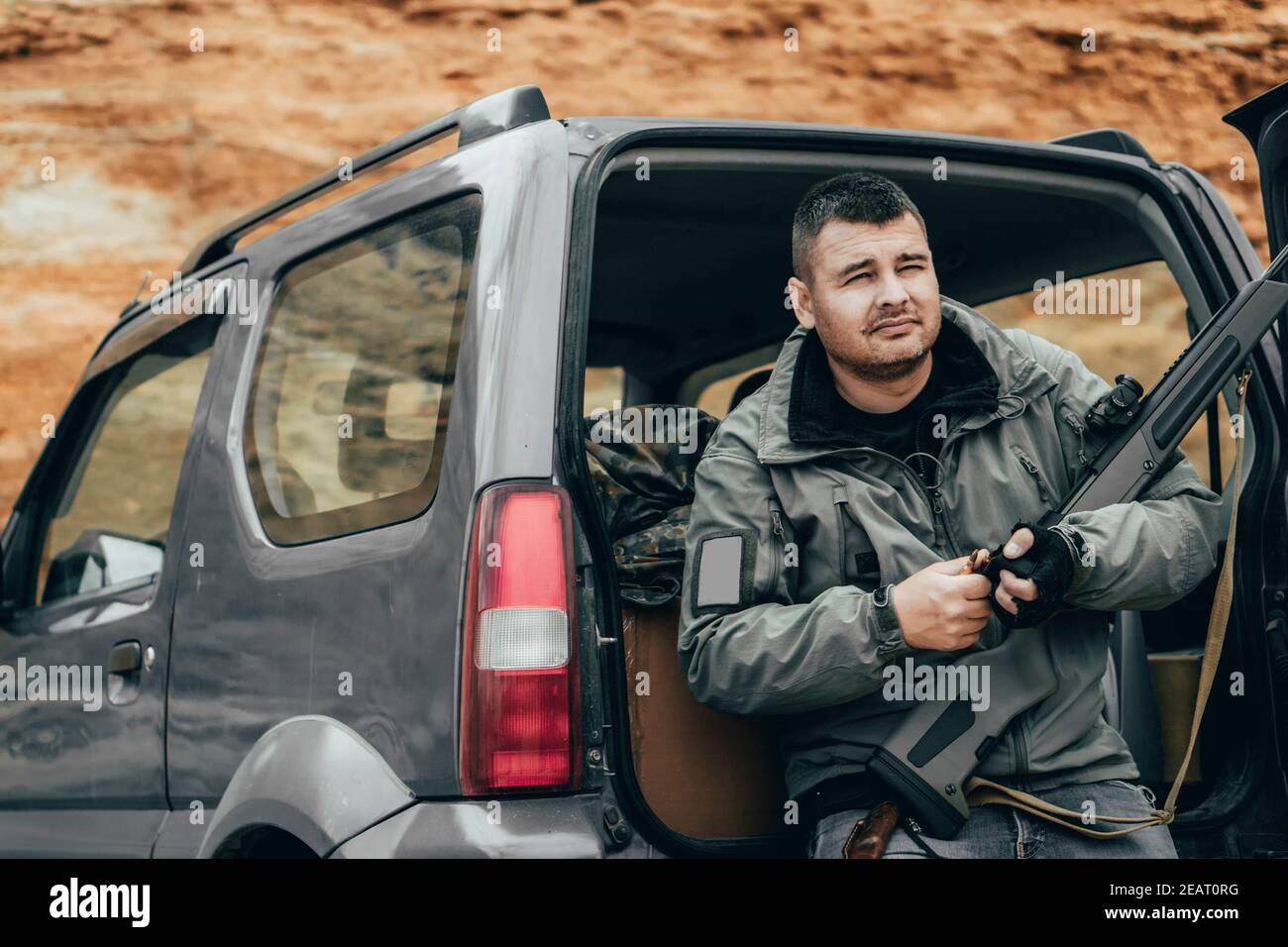 Private military contractor or hunter. Man reload rifle Stock Photo - Alamy